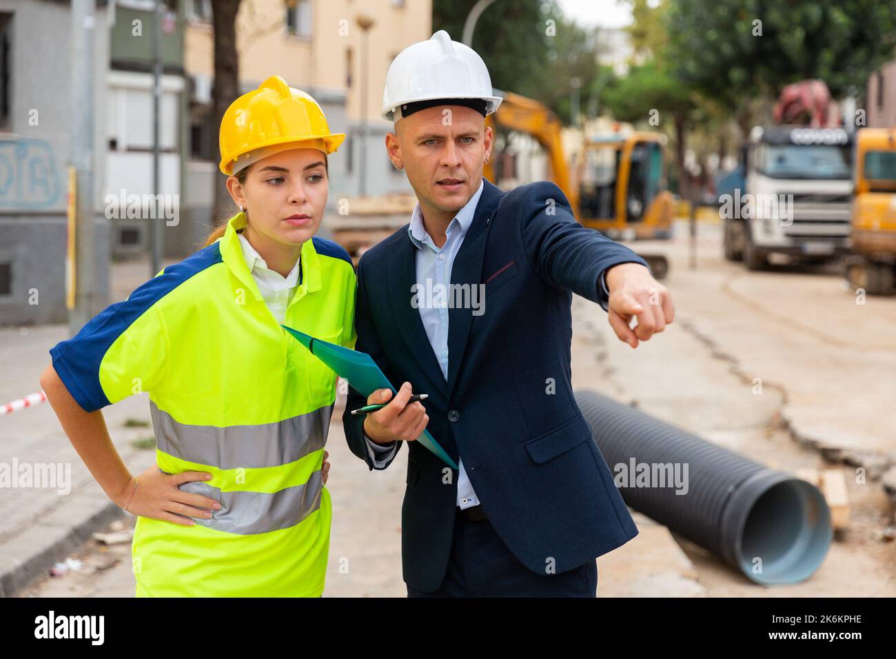 Civil engineers checking work process in construction site Stock Photo ...