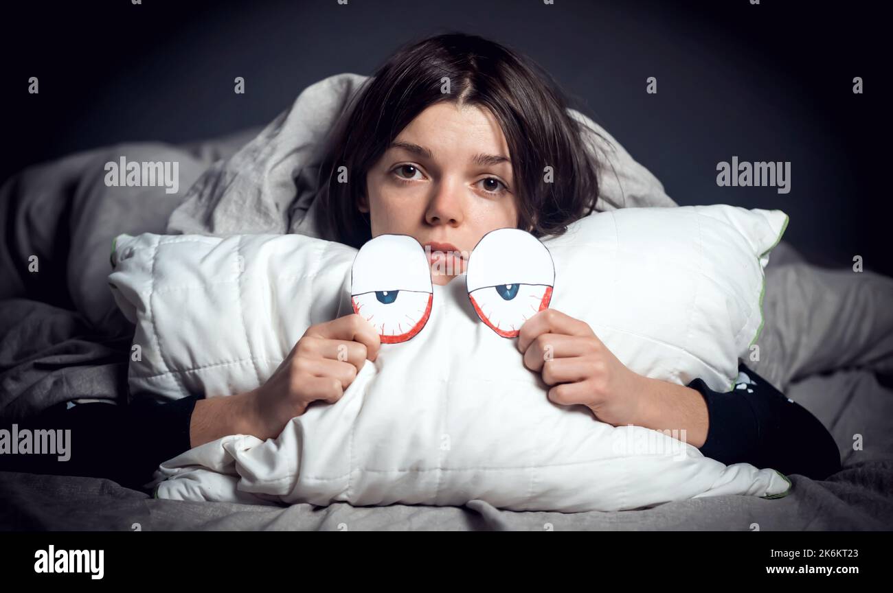 Young scared girl with pillow monster, nightmares Stock Photo - Alamy