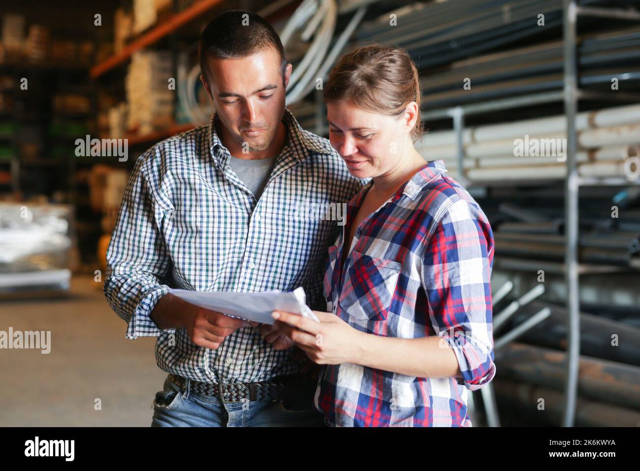 Manager and employee together checking availability of goods in ...