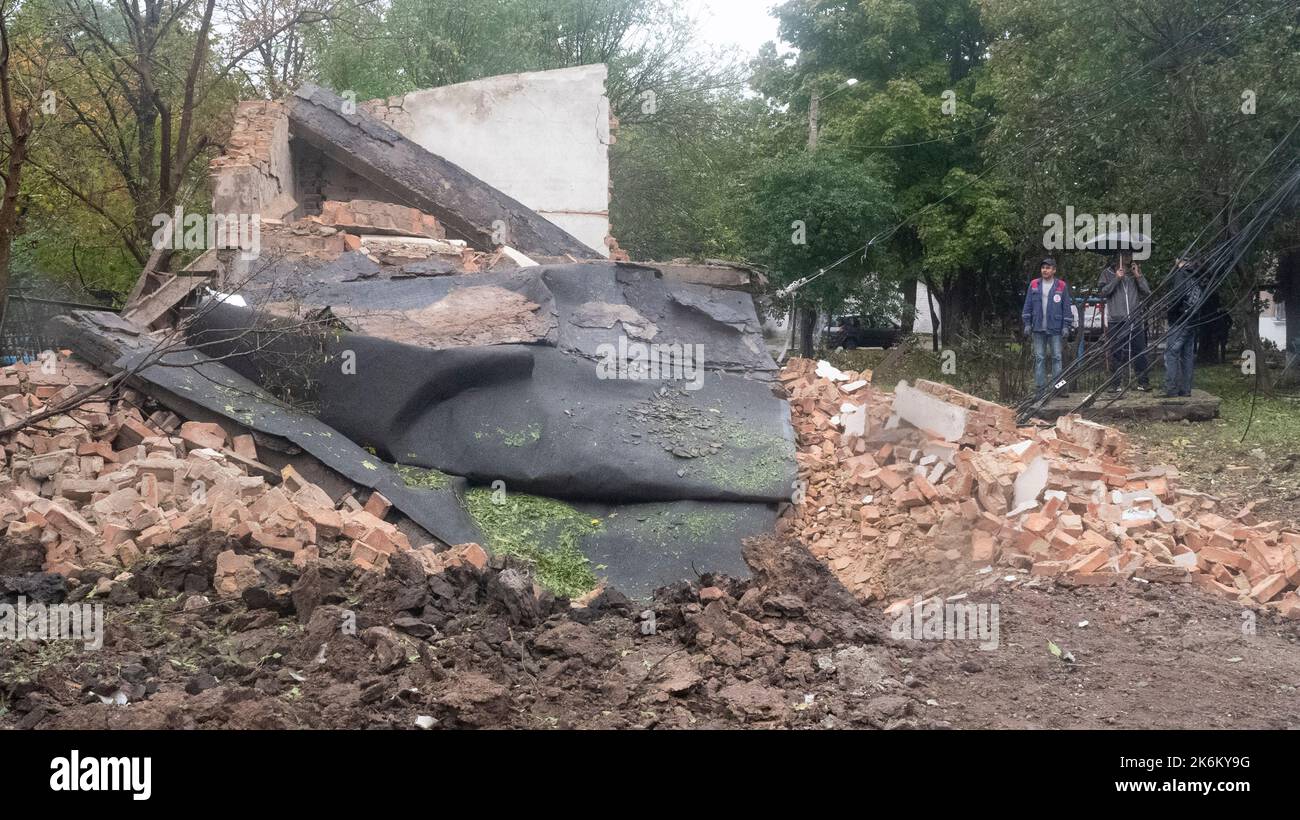 People look at a damaged building after a Russian missile strike Stock ...