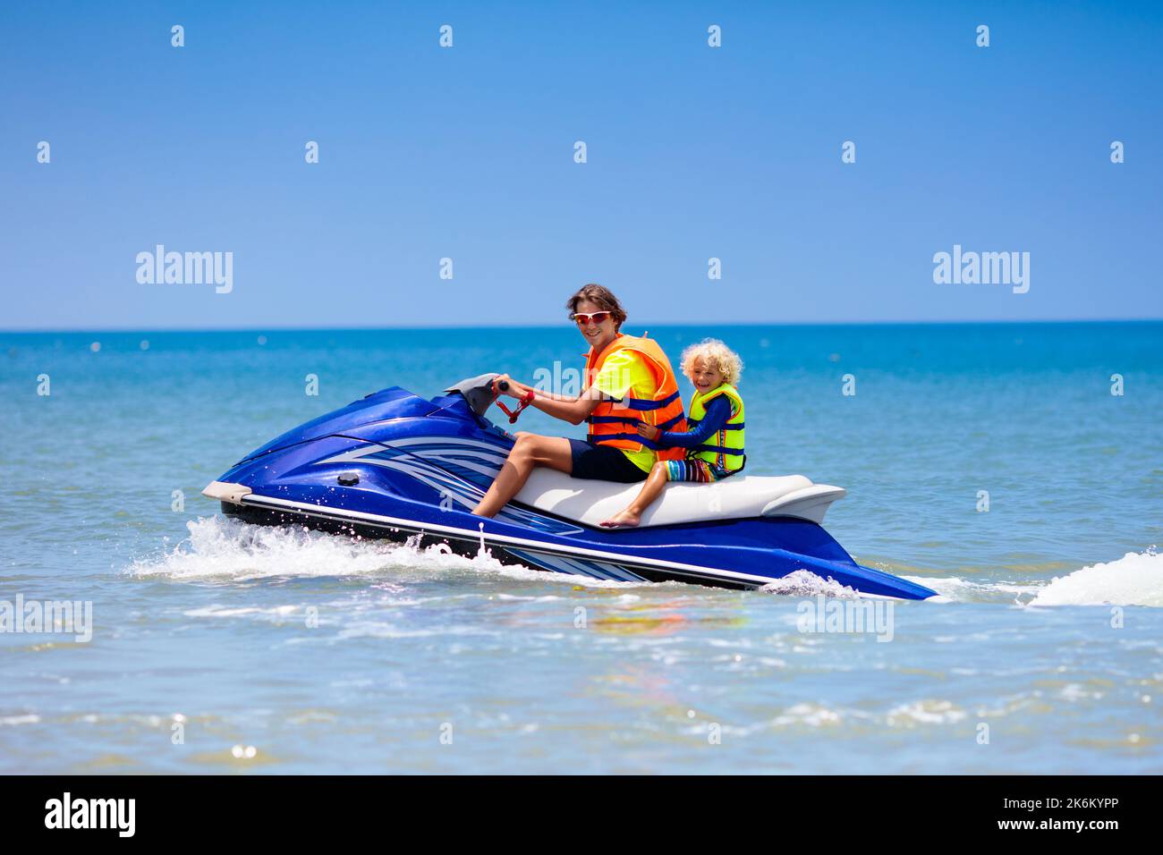 Family on jet ski. Teen age boy and little kids skiing on water scooter ...