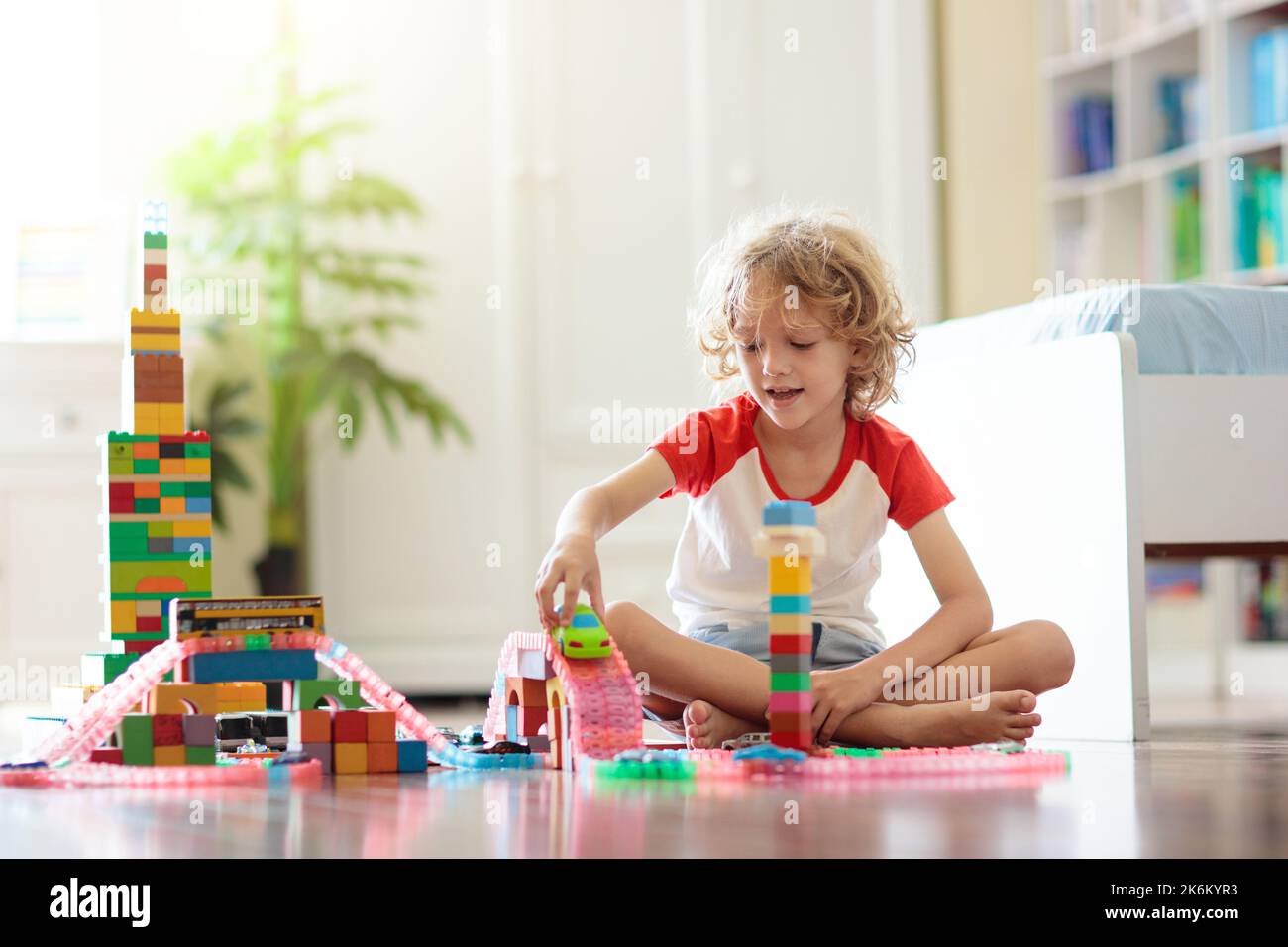 Kids play with colorful blocks. Little boy building tower at home or ...