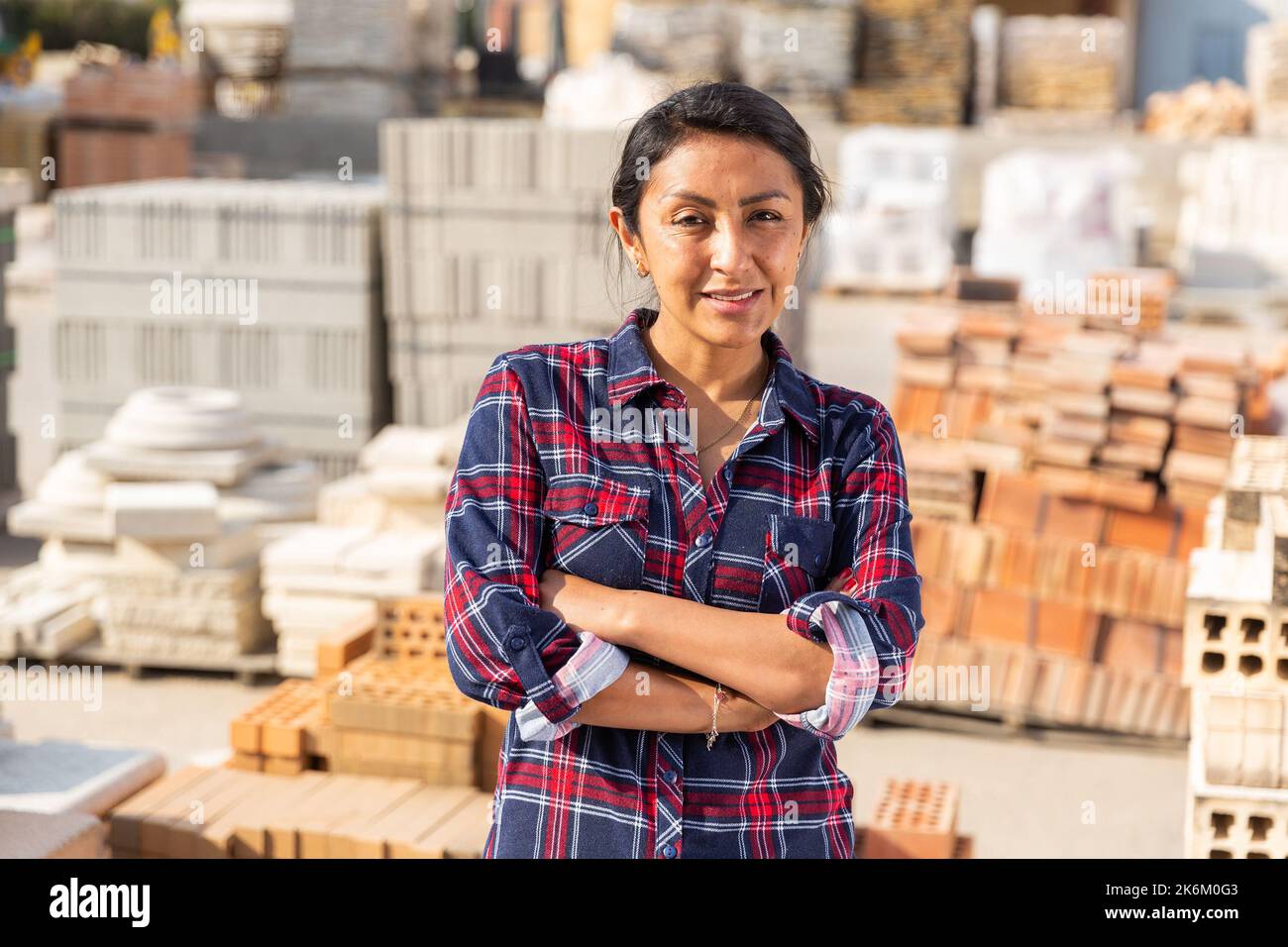 Portrait of woman seller of building materials at an open-air site ...