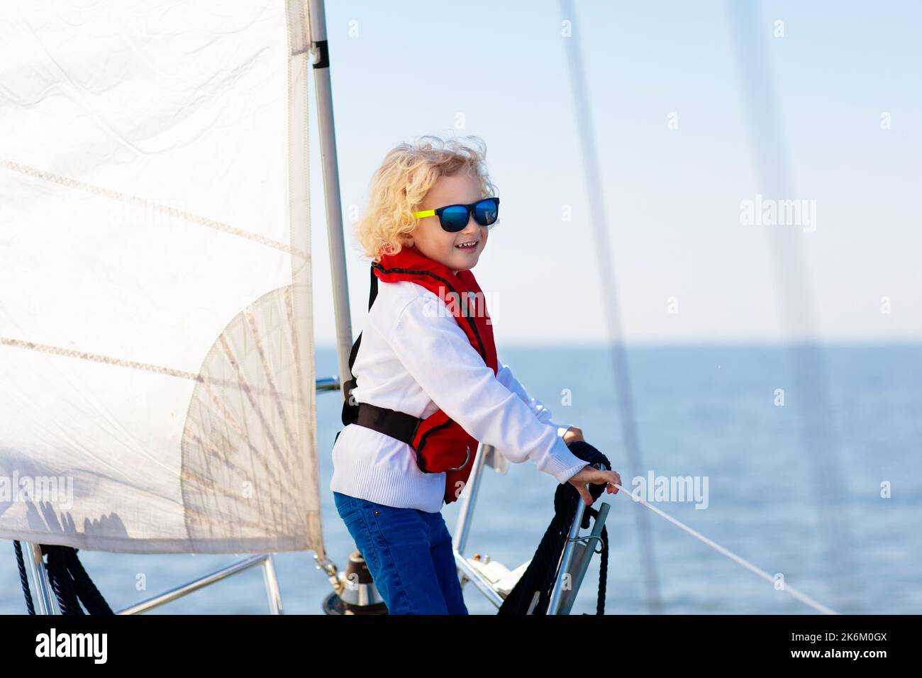Kids sail on yacht in sea. Child sailing on boat. Little boy in safe ...