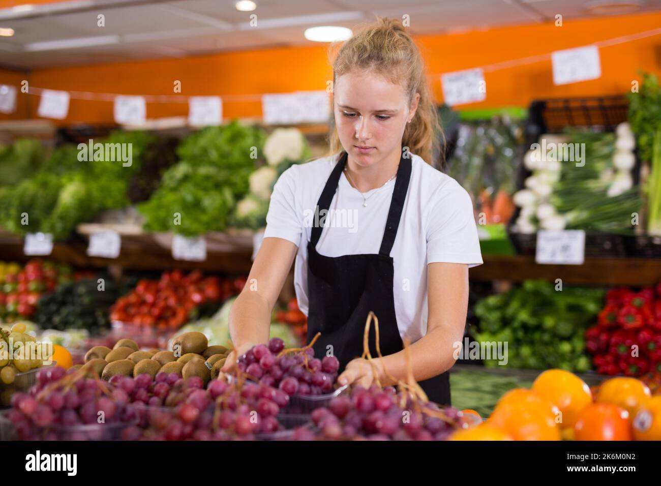 Teenage girl working in grocery as job experience Stock Photo - Alamy