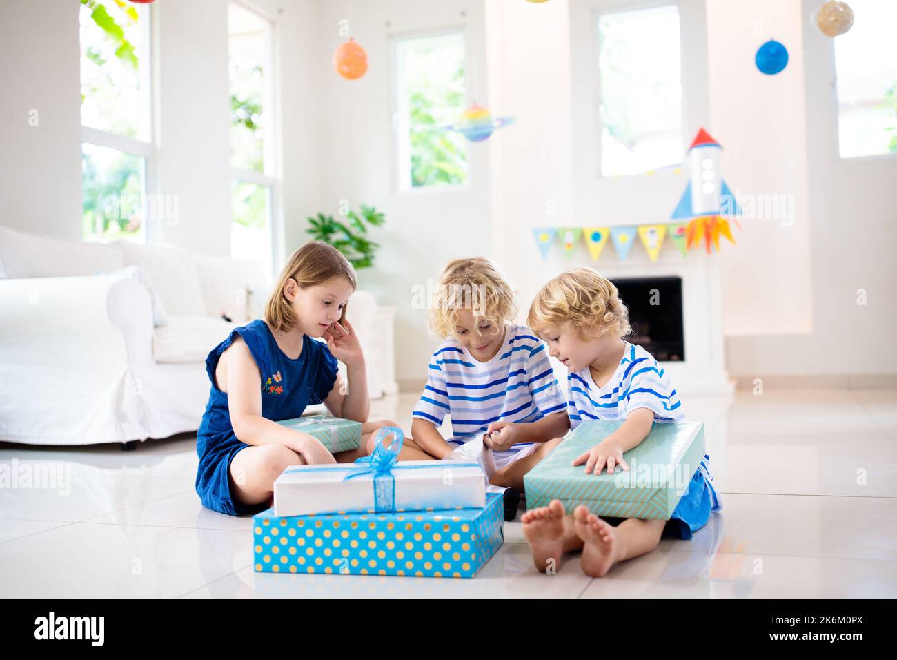 Space theme kids birthday party. Boy with present. Children celebration ...