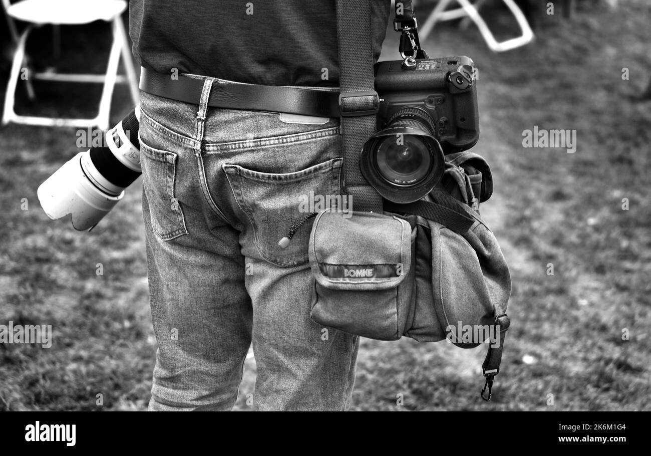 A newspaper photographer with Canon cameras and a Domke camera bag ...