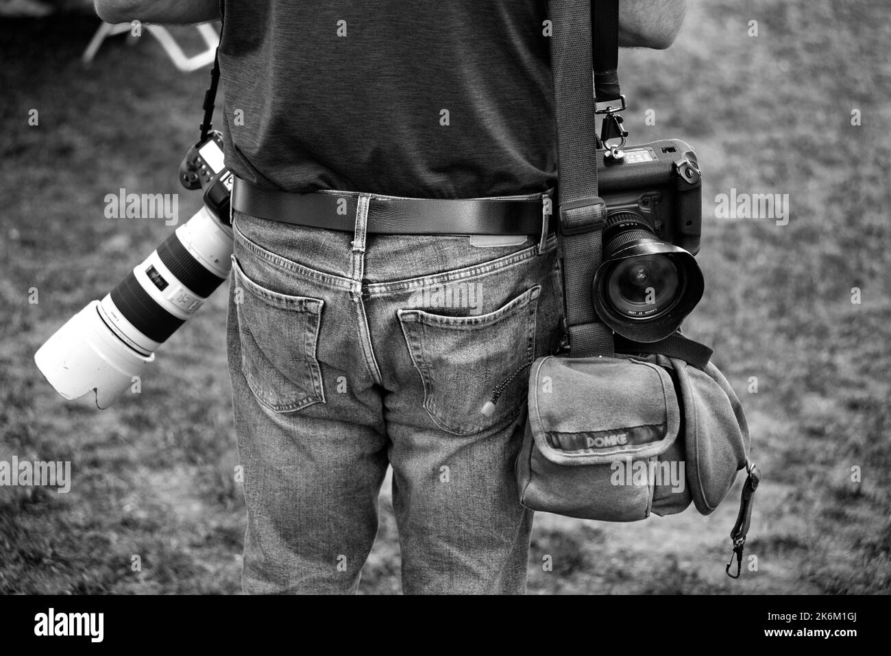 A newspaper photographer with Canon cameras and a Domke camera bag ...