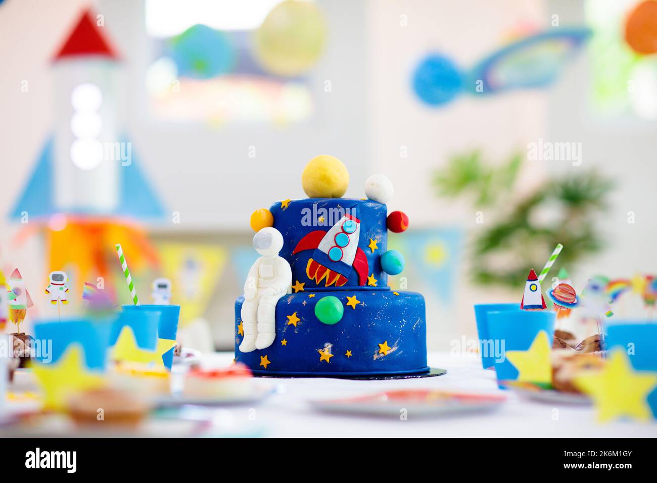Kids space theme birthday party with cake and cupcakes. Rocket, solar ...