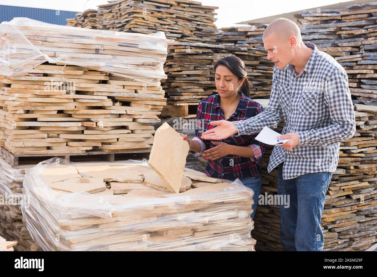 Buyers choose natural stone tiles in the open area of hardware store ...