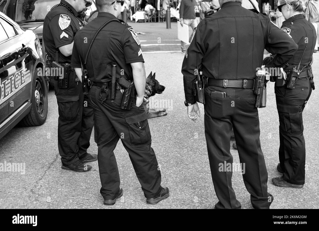 Police officers and a police dog gather for an informal meeting at an ...