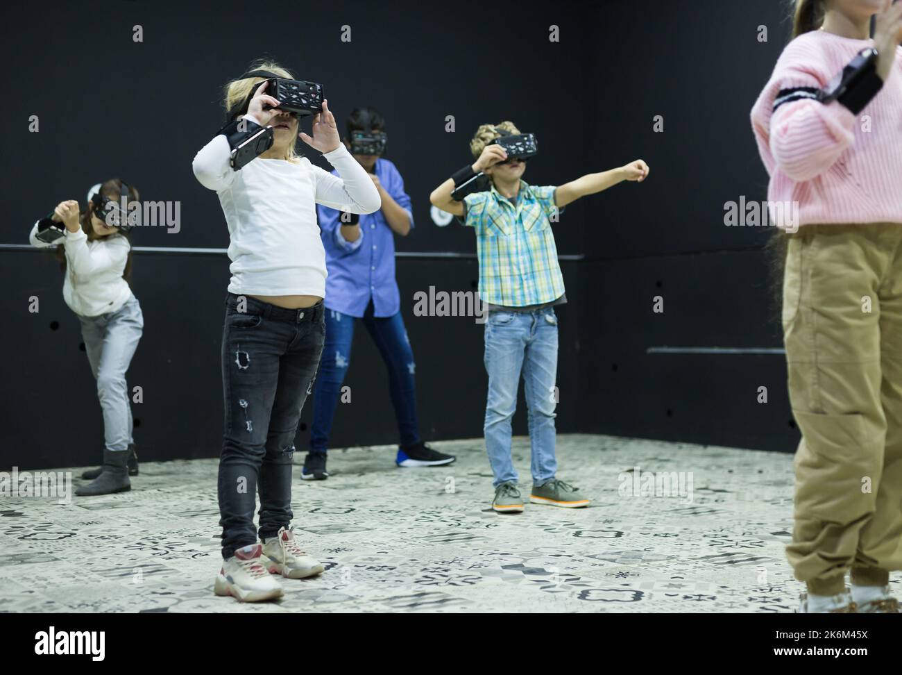 Tween kids having fun with vr headset goggles Stock Photo - Alamy