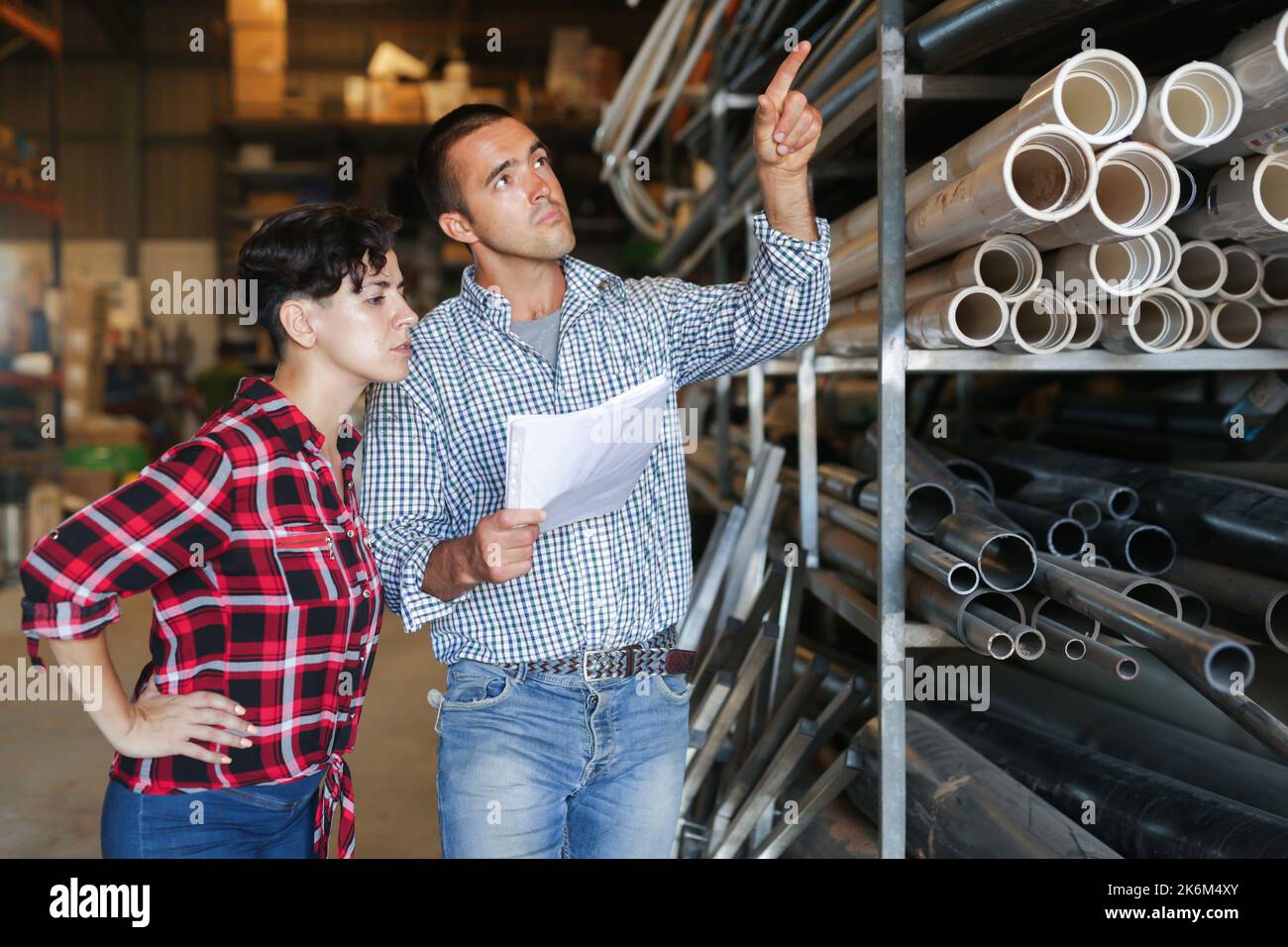 Man and woman together carry out accounting and inventory in a building ...