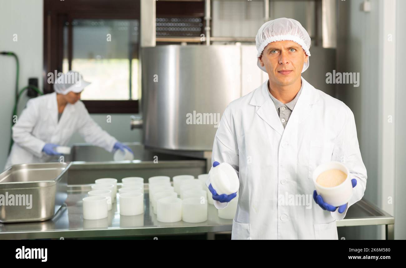 Young man cheese wheel hi-res stock photography and images - Alamy