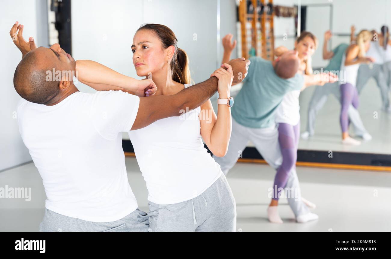 Hispanic girl practicing elbow strike during self defence course Stock ...