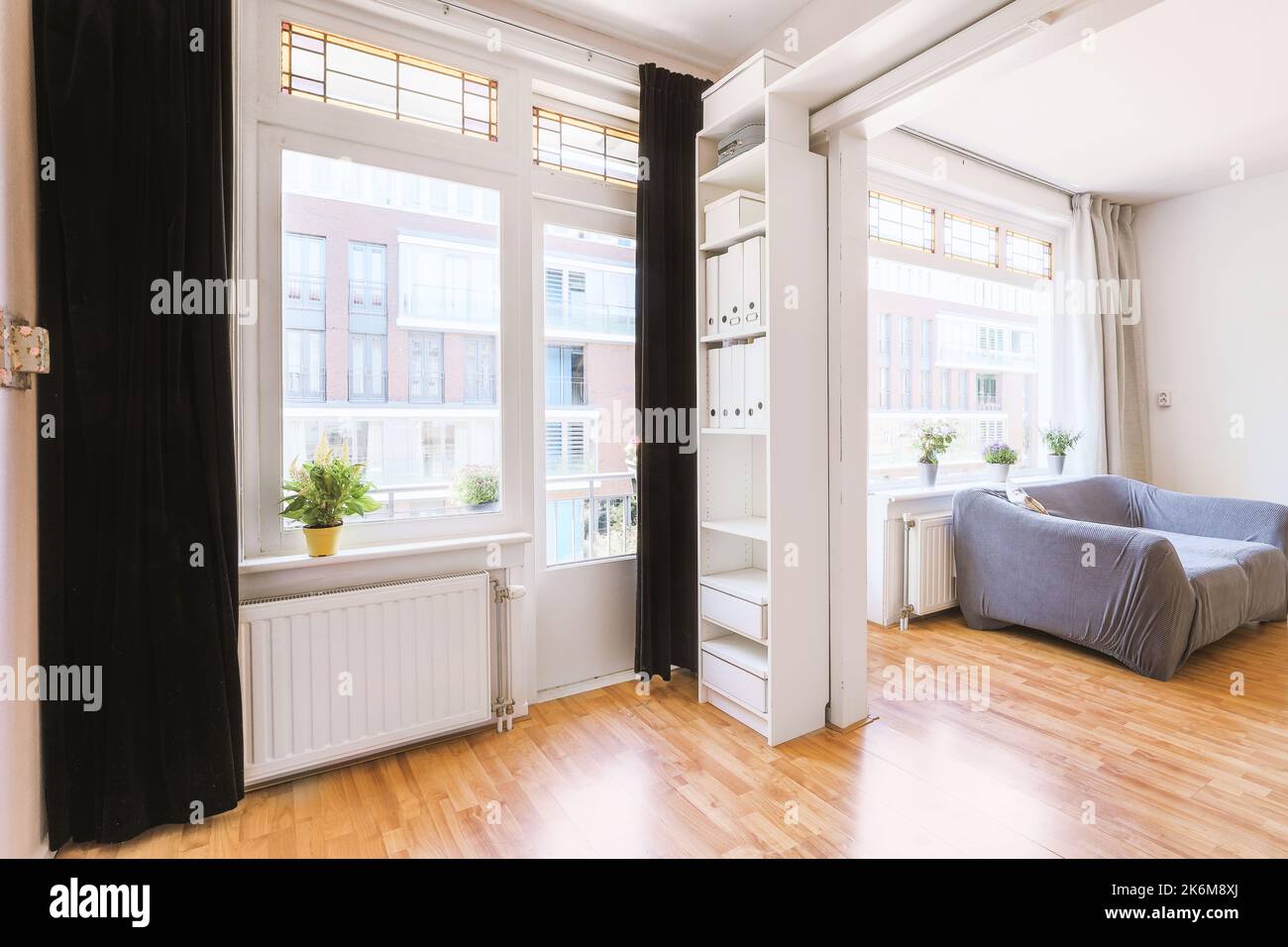 Interior of spacious room with chests of drawers in apartment designed ...