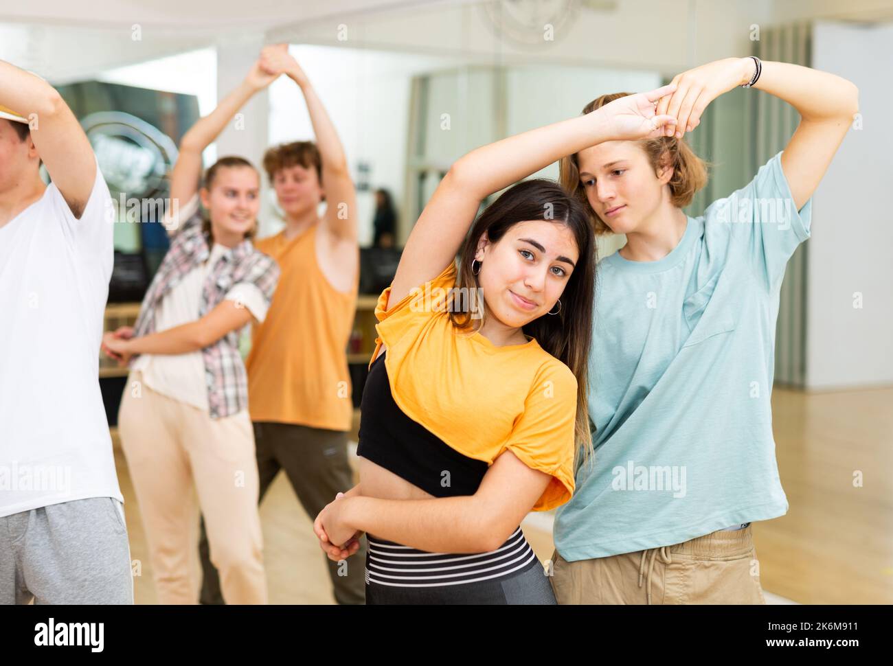 Teenagers dancing in pairs slow ballroom dances in choreography class ...