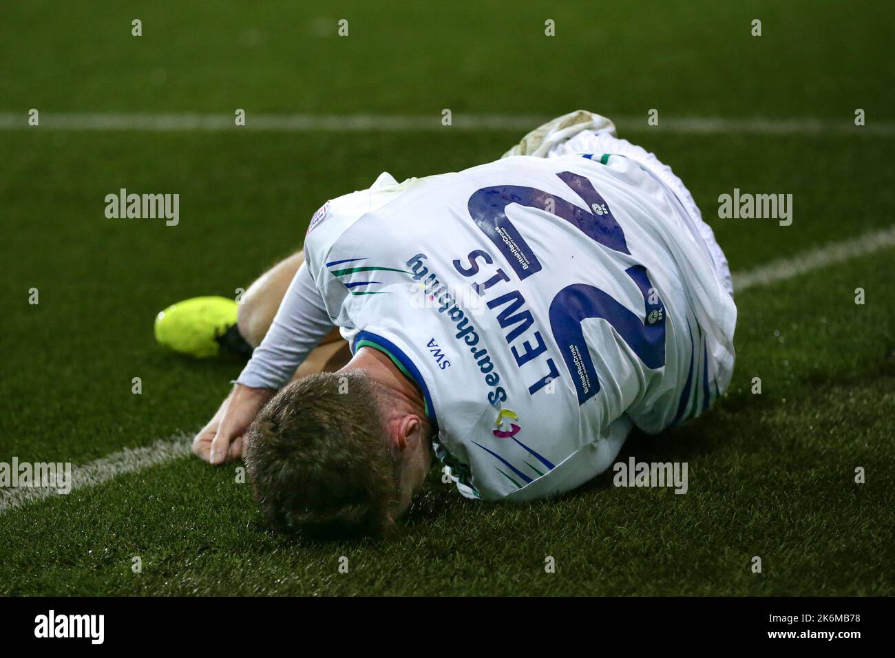Paul Lewis #22 of Tranmere Rovers punches the ground in pain during the ...