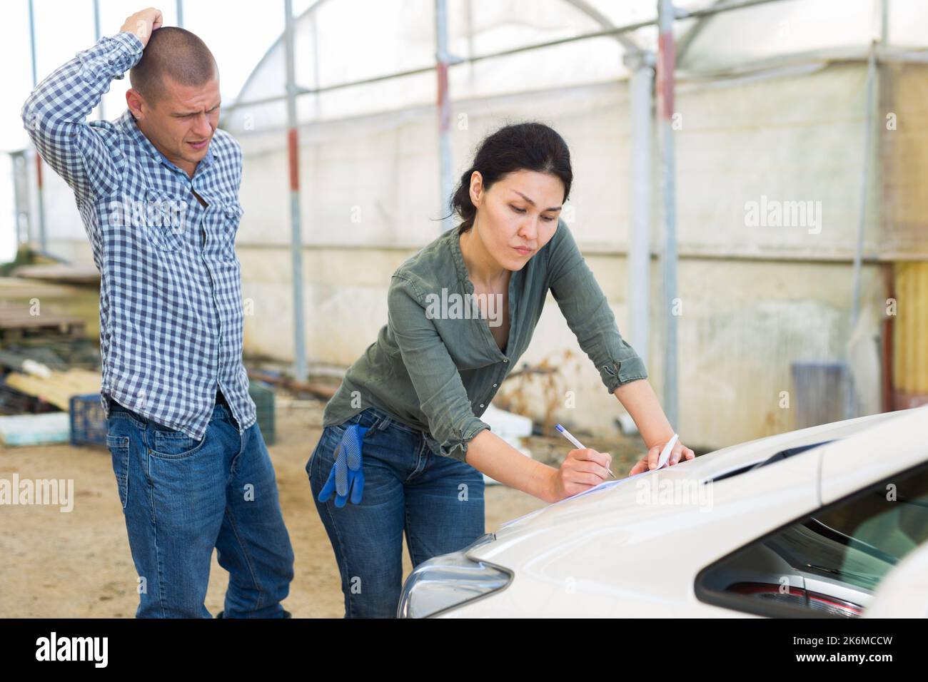 Farmer signing contract with representative of transport company Stock ...