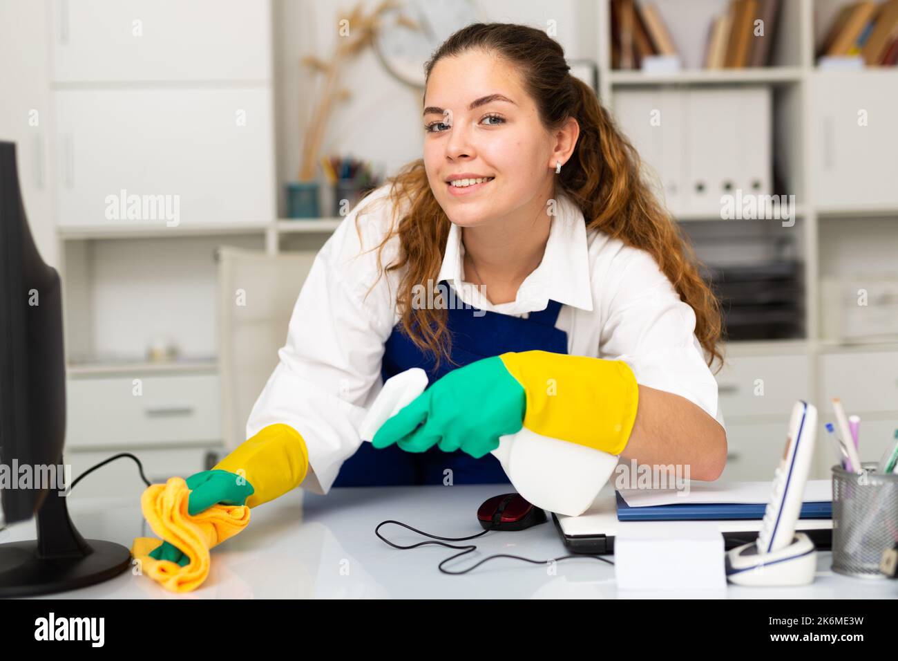 Young friendly cleaning woman in work uniform Stock Photo - Alamy