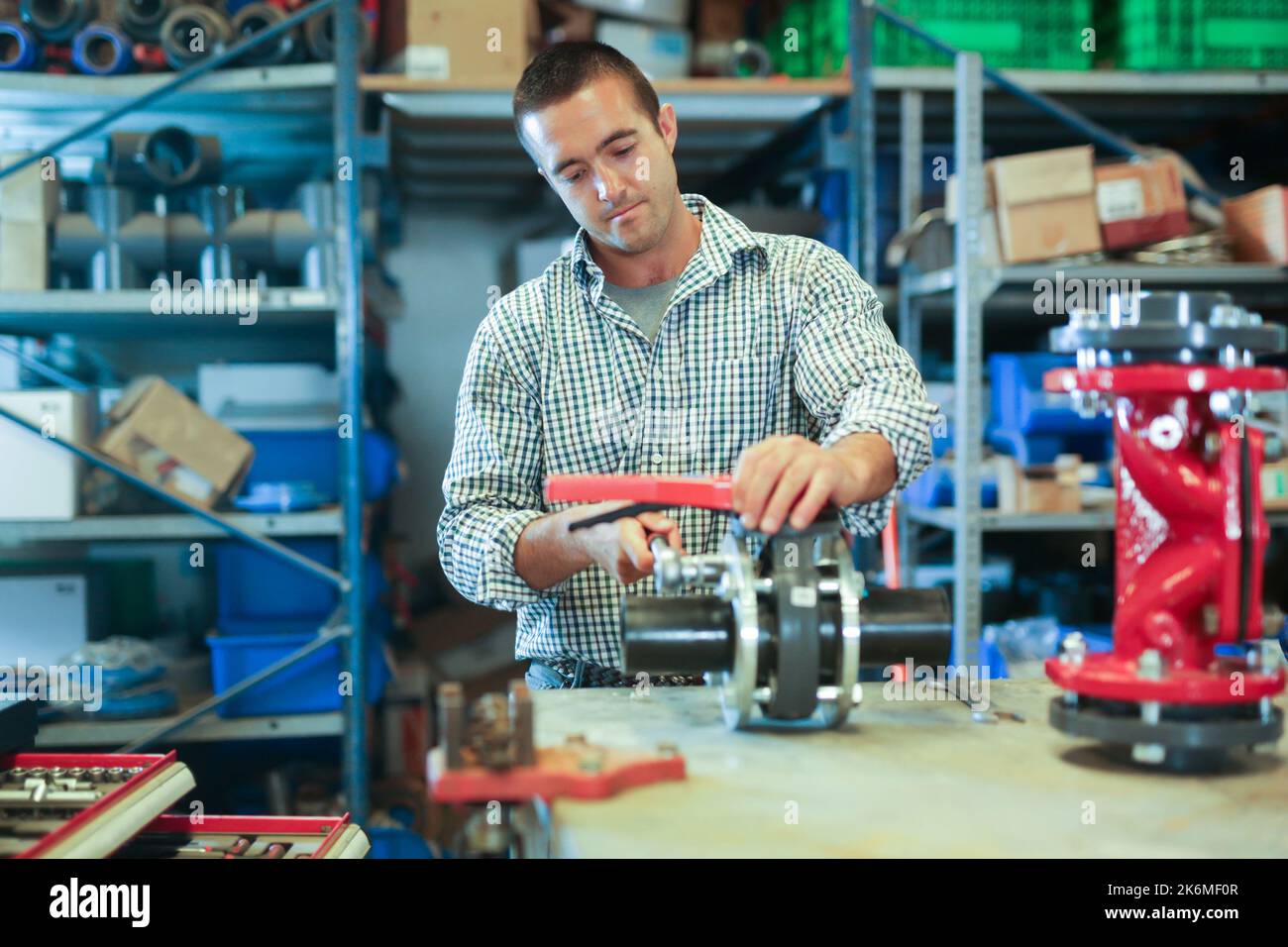 Worker fixing pipe fitting in repair service Stock Photo - Alamy