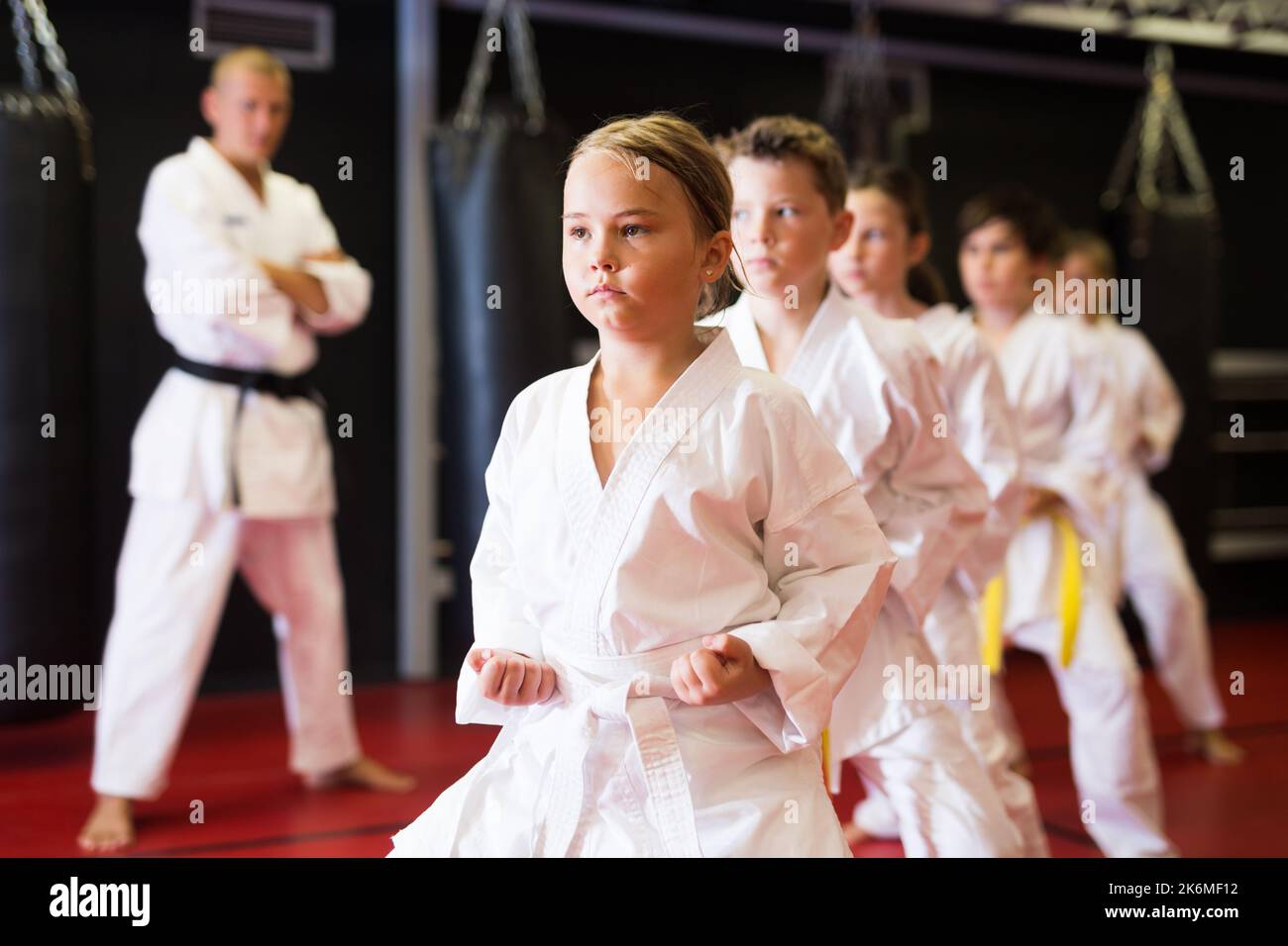 Girl practicing new moves during karate class Stock Photo - Alamy