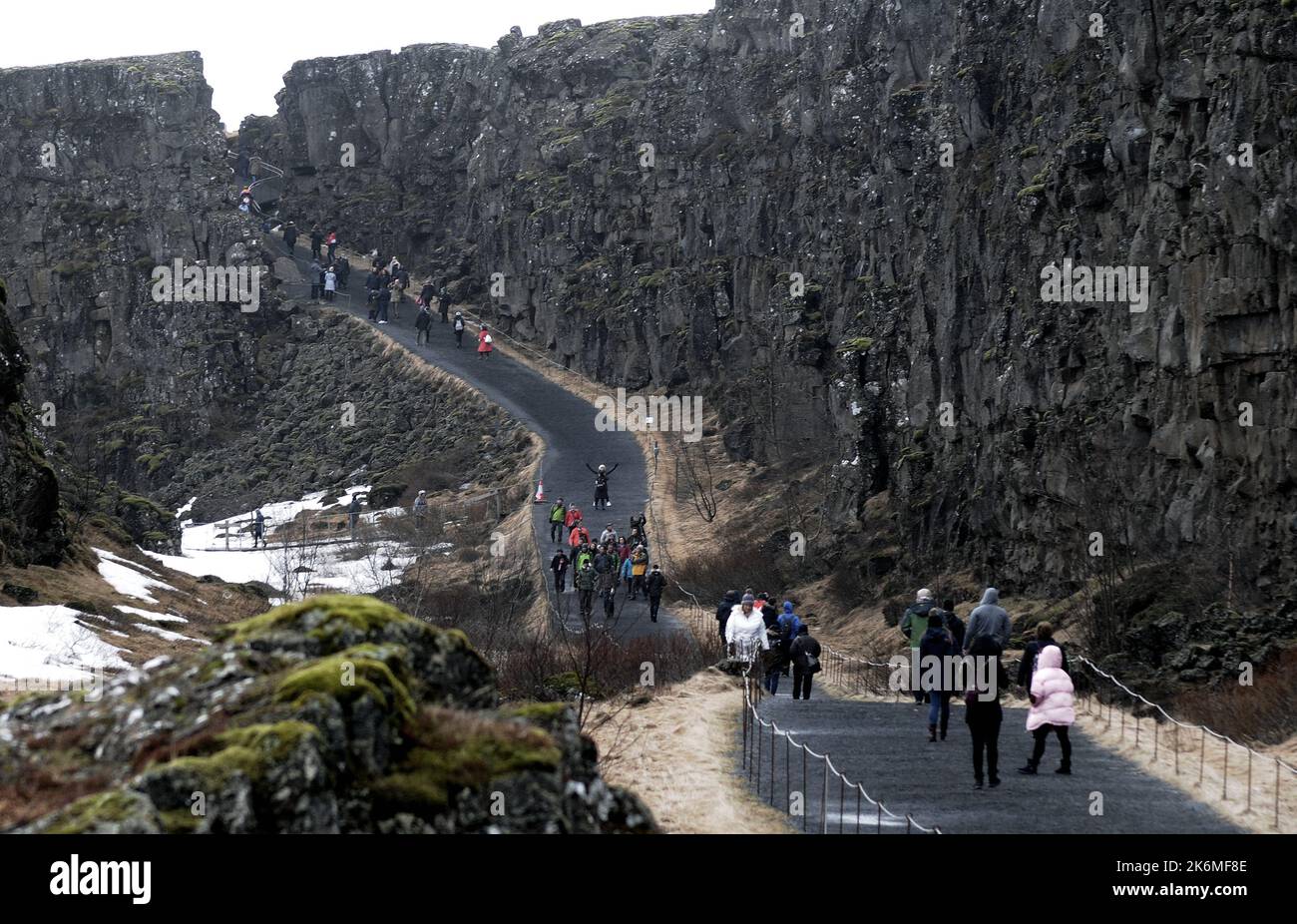 TOURISTS EXPLORE THINGVELLIR, THE MID ATLANTIC TECTONIC PLATE, ICELAND ...