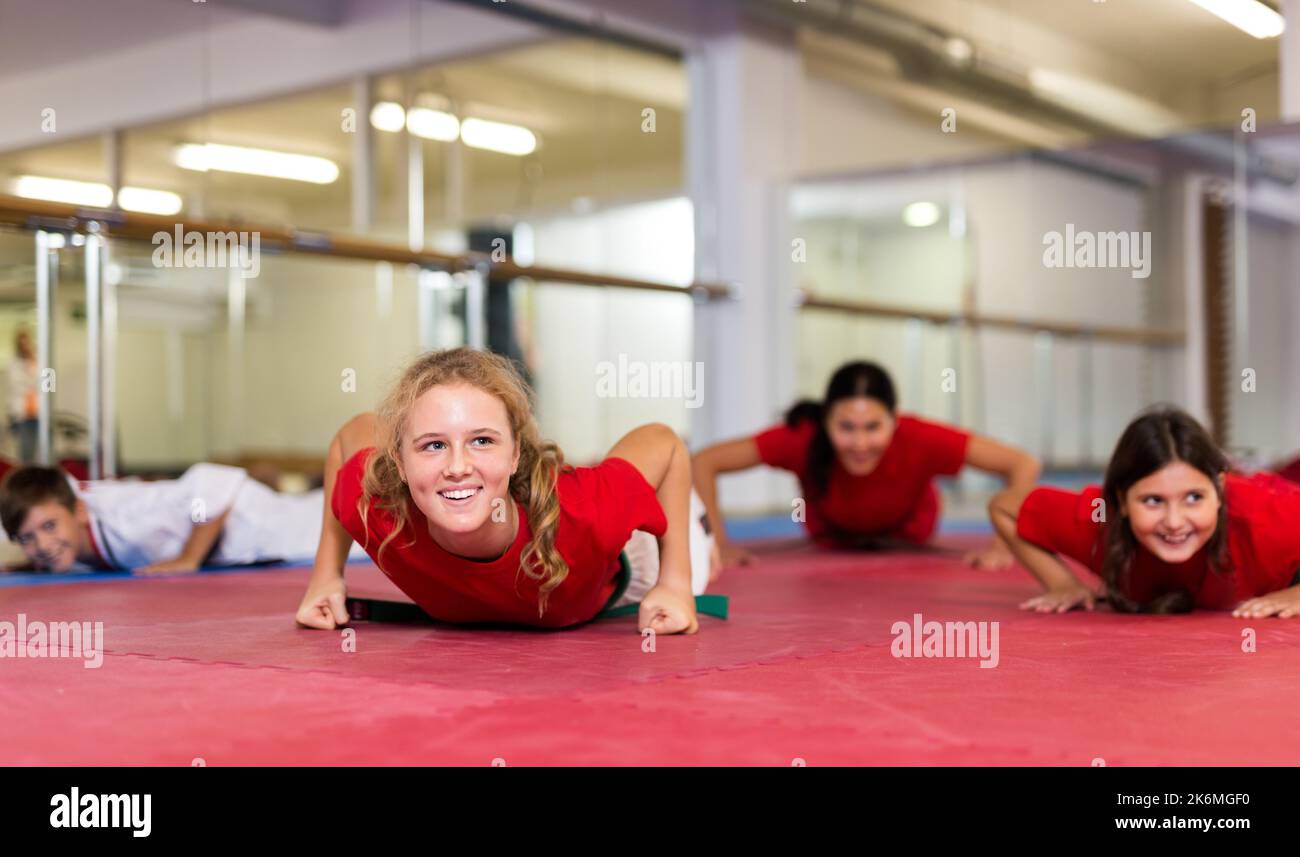 Karate kids doing push-ups in gym Stock Photo - Alamy