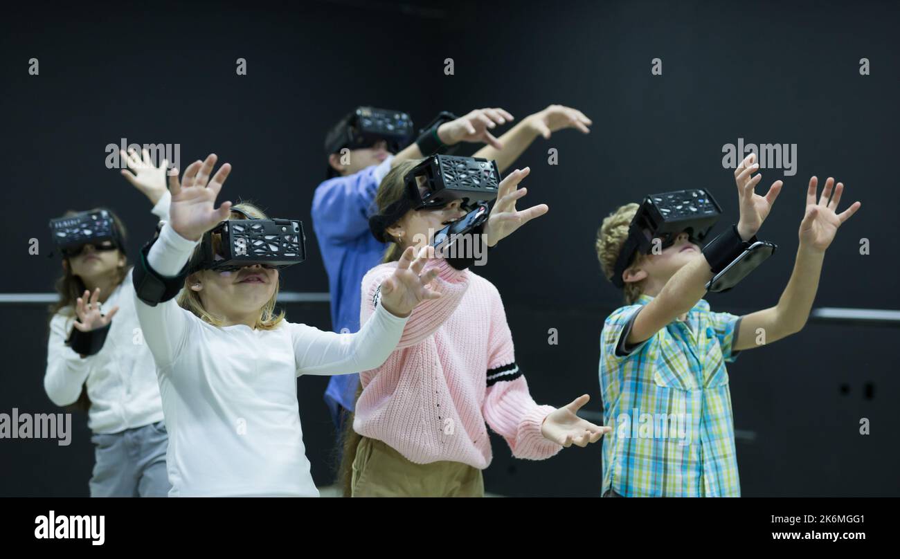 Tween kids having fun with vr headset goggles Stock Photo - Alamy