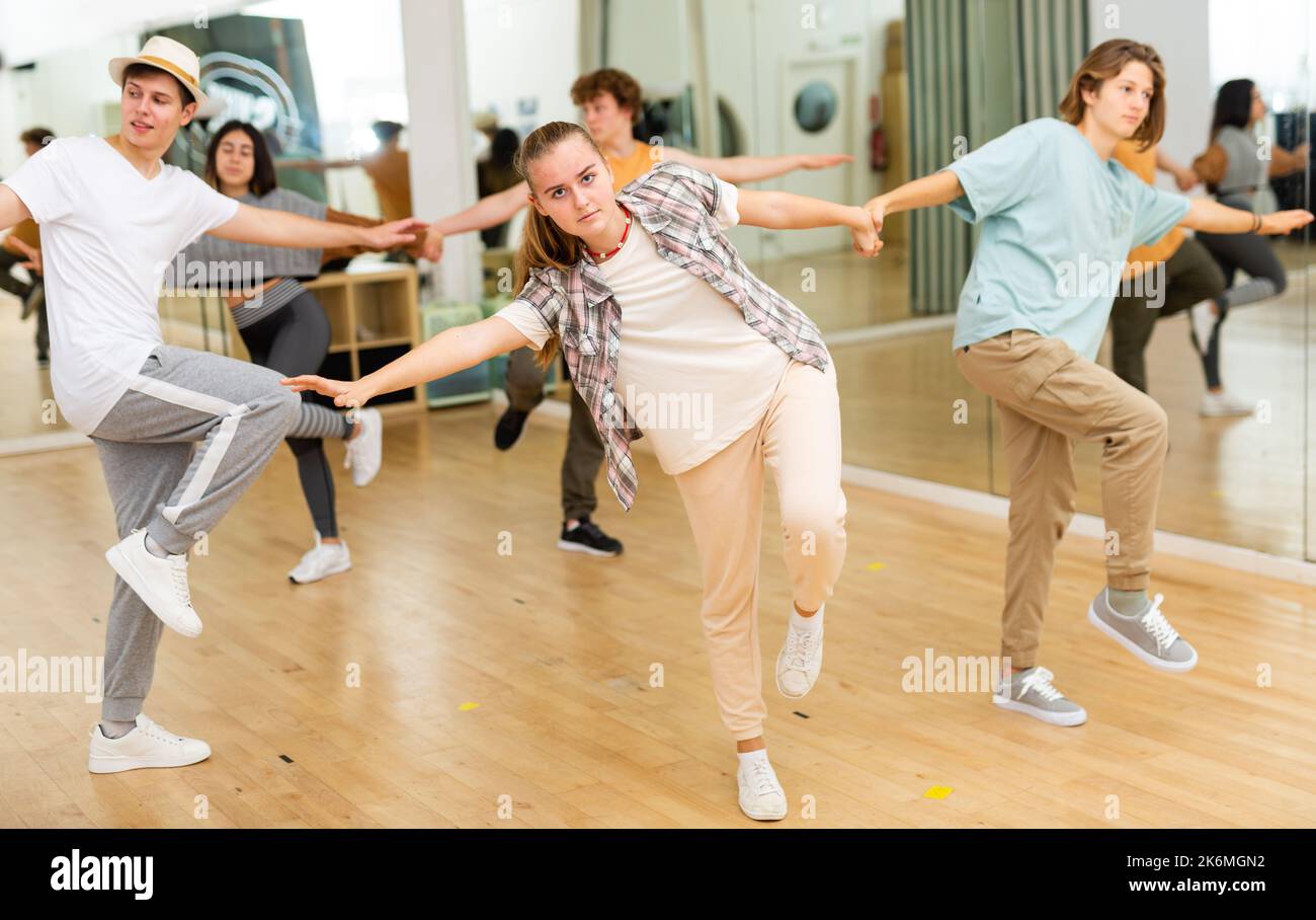Modern teen girl practicing dynamic boogie-woogie in pair with boy ...