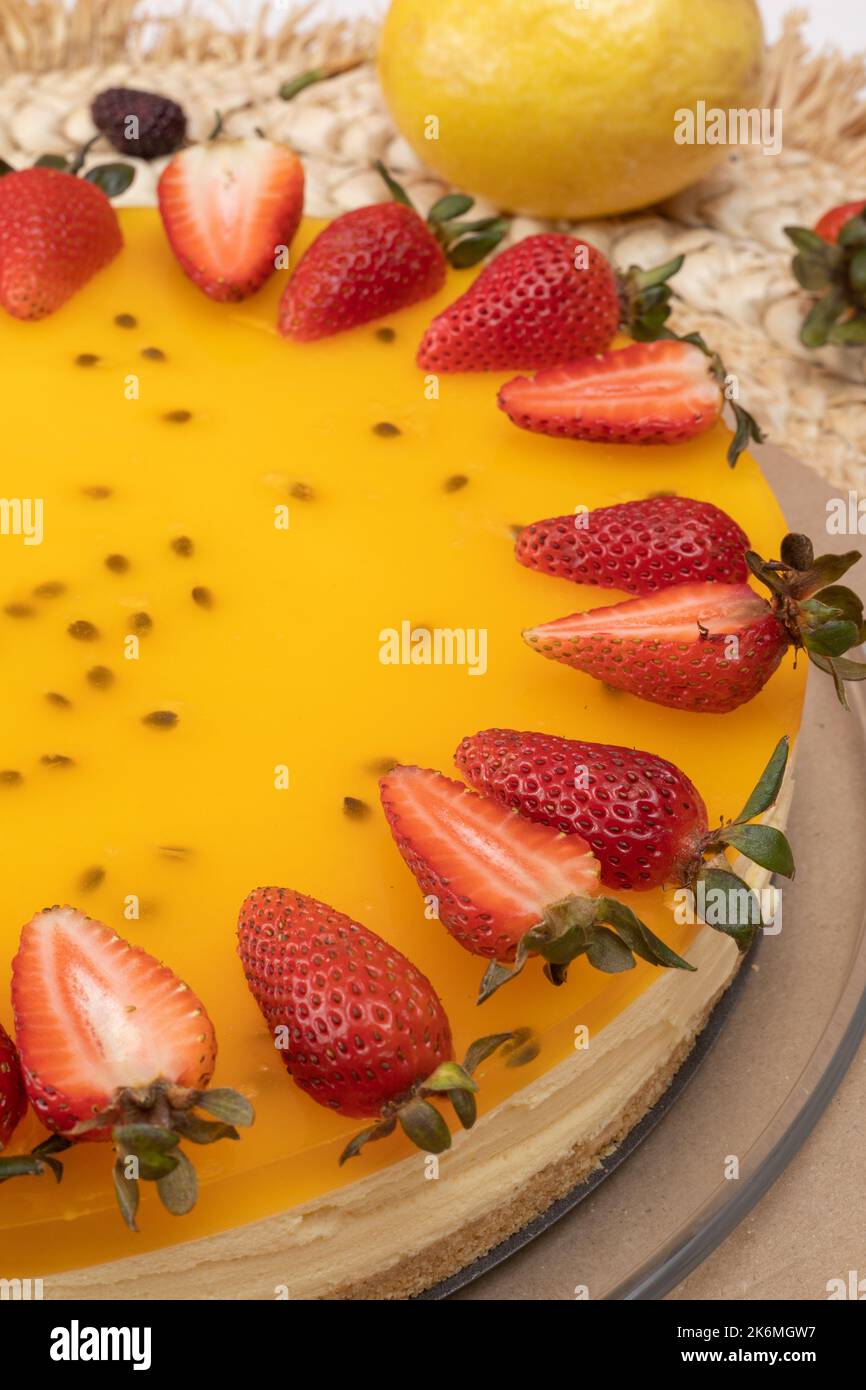 pastry table with passion fruit cheesecake with cream decorated with ...