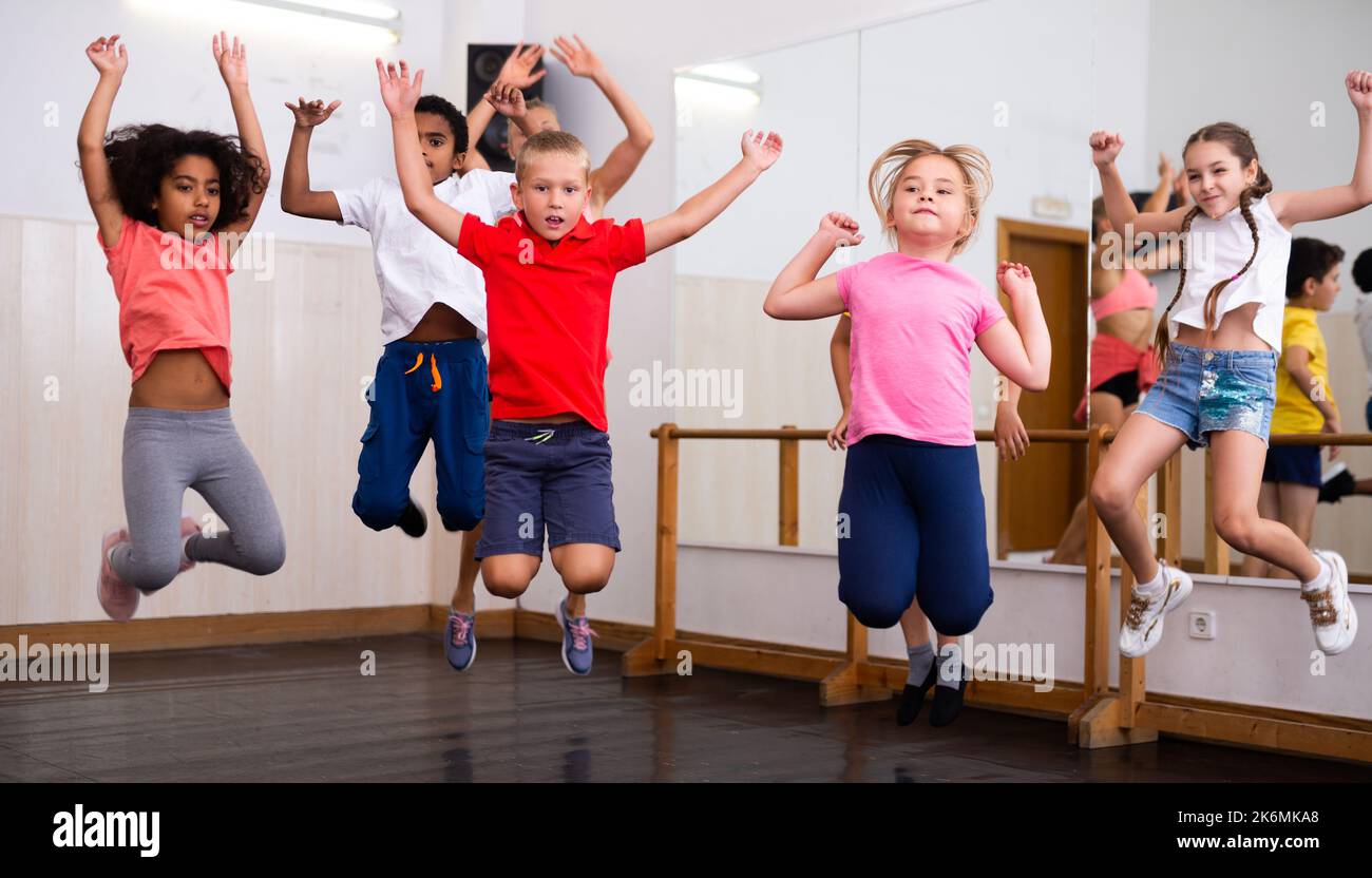 Dancing and jumping happy boys and girls hi-res stock photography and ...