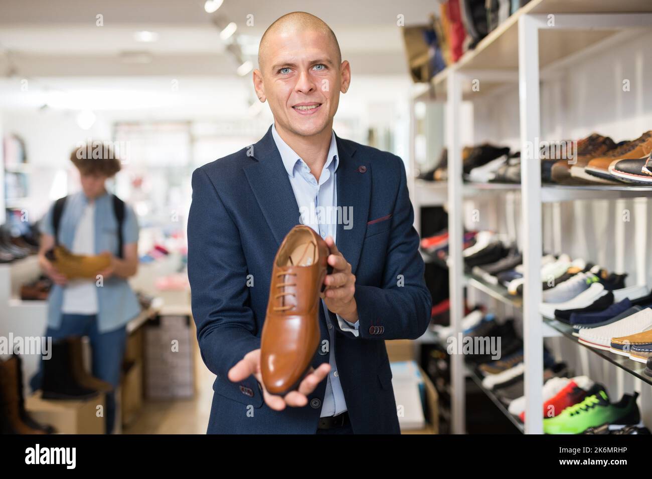 Brown male shop assistant hi-res stock photography and images - Alamy