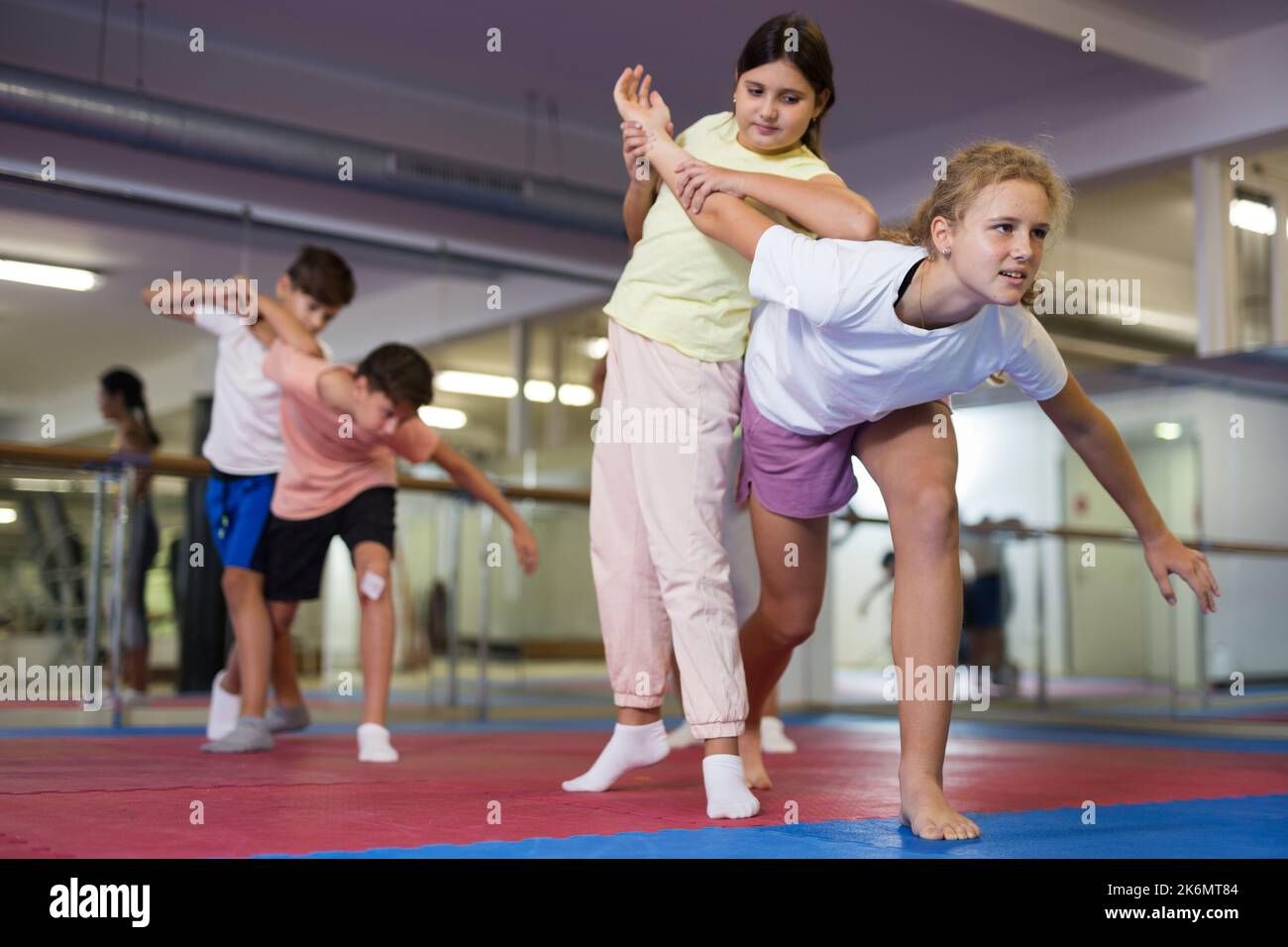 Two girls learn to do a painful hand grip in self-defense lesson Stock ...