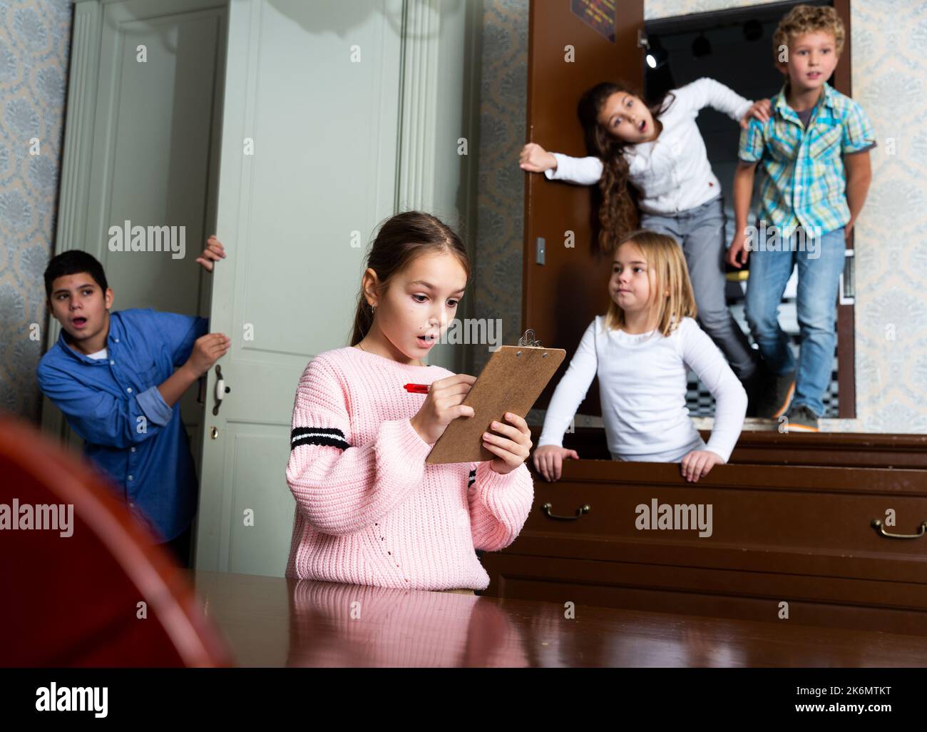 Children are trying to find a way out of quest room Stock Photo - Alamy