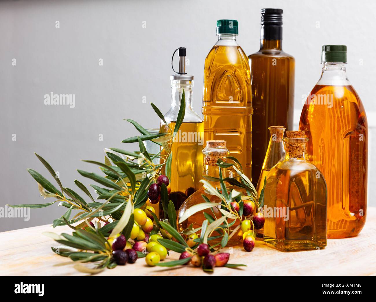 Olive oil in bottles on wooden table Stock Photo - Alamy