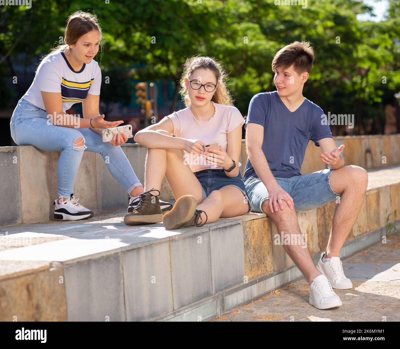 Teenagers have fun talking on the street Stock Photo - Alamy
