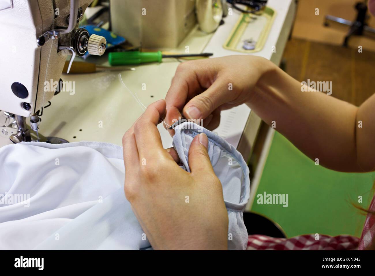 Seamstress works sewing in shop in Omotesando, Tokyo, Japan Stock Photo ...