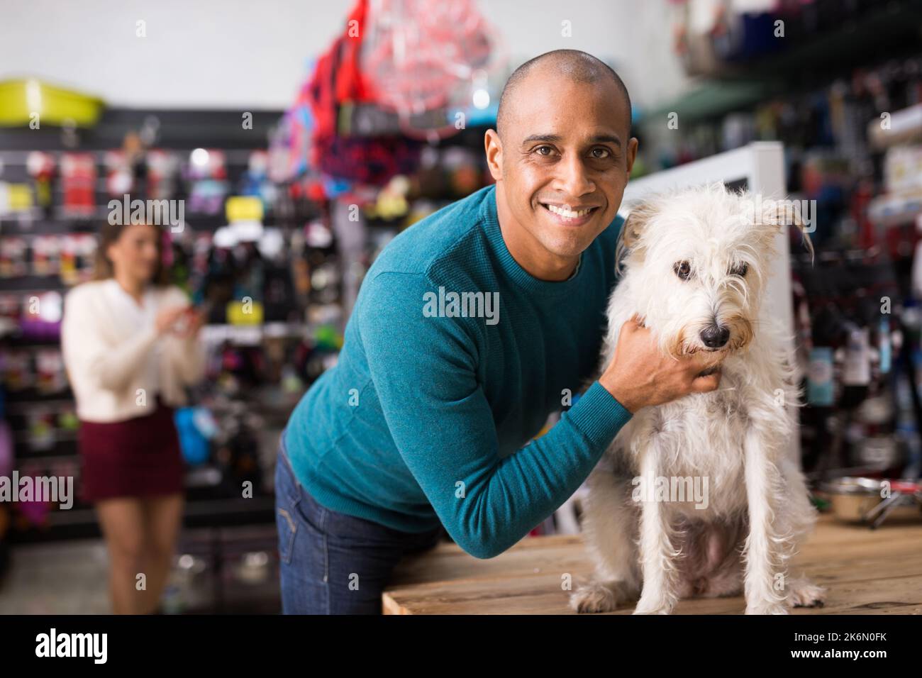 Emotional man hugging dog in pet store Stock Photo - Alamy