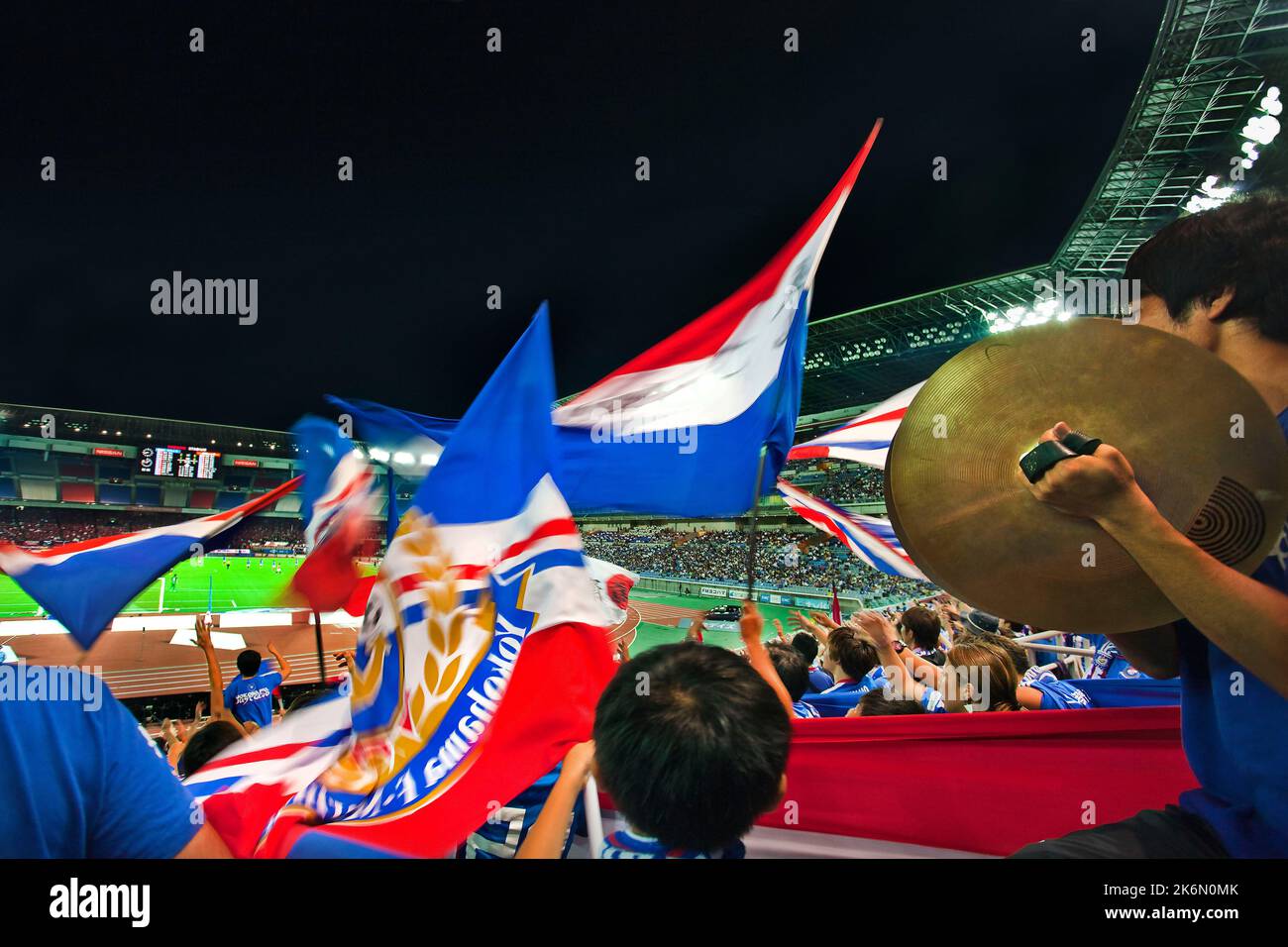 Soccer fans celebrate a goal, cheering and waving flats at Nissan ...