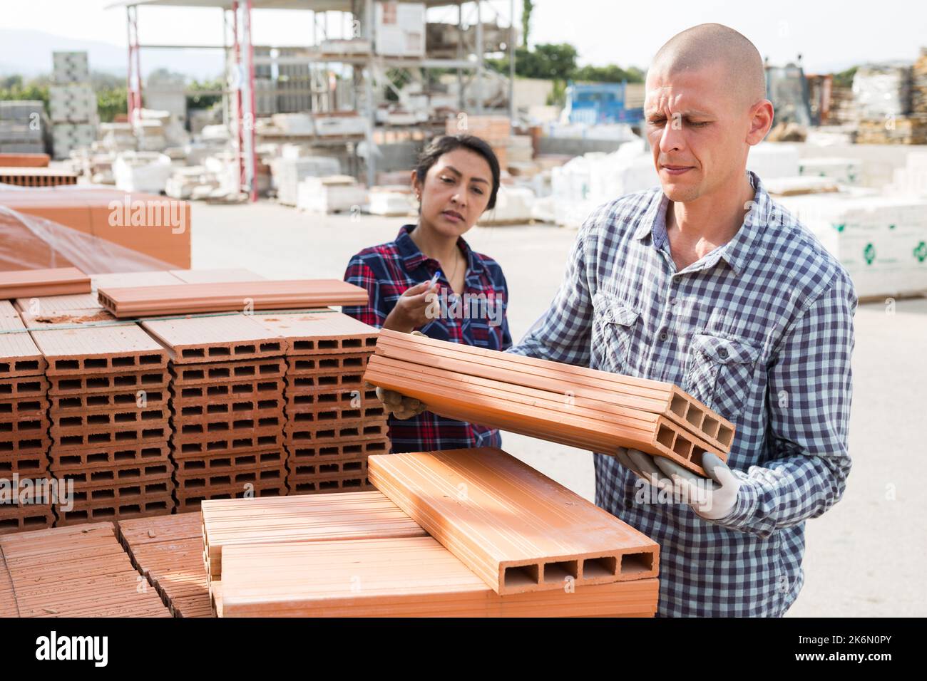Builder is choosing bricks in building store Stock Photo - Alamy
