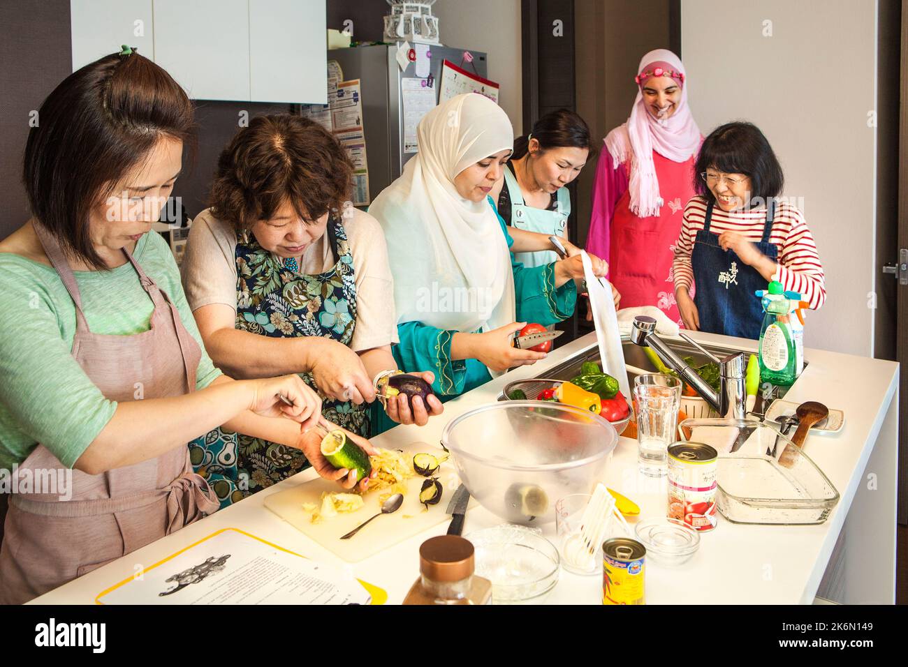 Students and teachers prepare vegetables at Tunisian cooking class ...