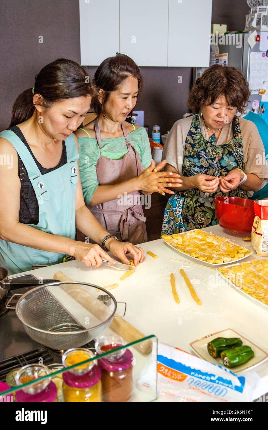 Students prepare dough for donuts, yuyu, Tunisian cooking class ...