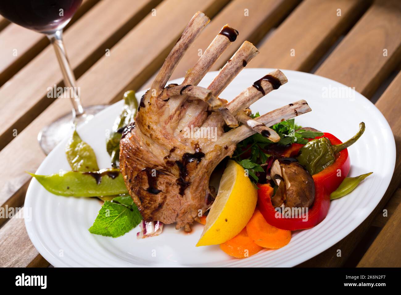 BBQ lamb carre served with vegetables Stock Photo - Alamy