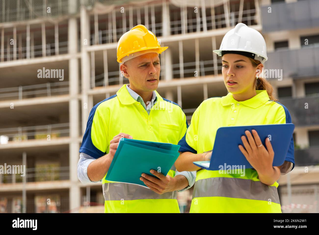 Man and woman engineers in construction site Stock Photo - Alamy