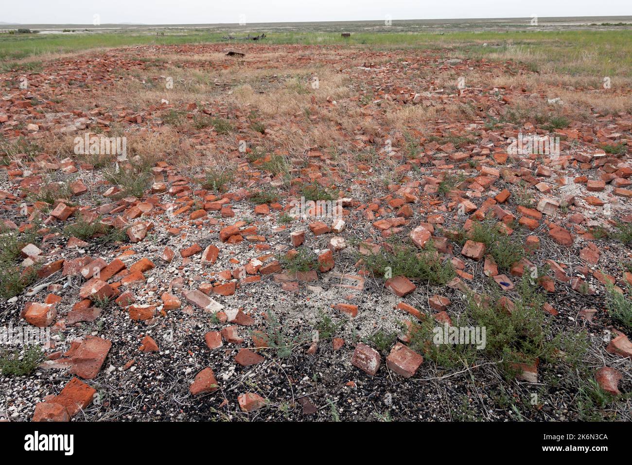 Brick debris from demolished buildings litter the ground in the form ...
