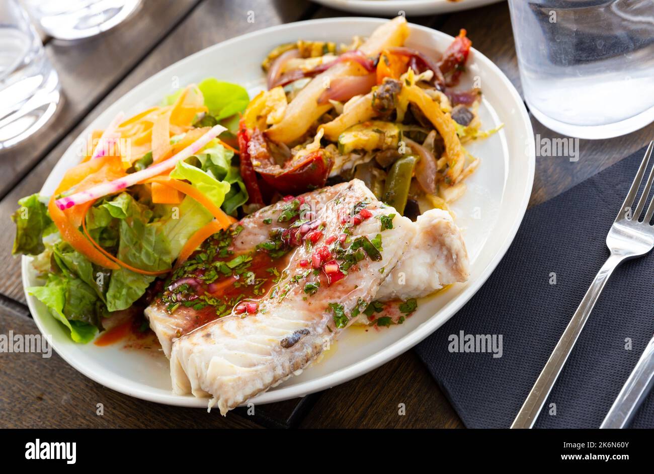 French-style molva or sea pike with vegetables Stock Photo - Alamy