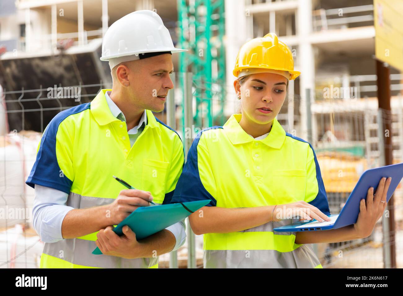 Man and woman engineers in construction site Stock Photo - Alamy