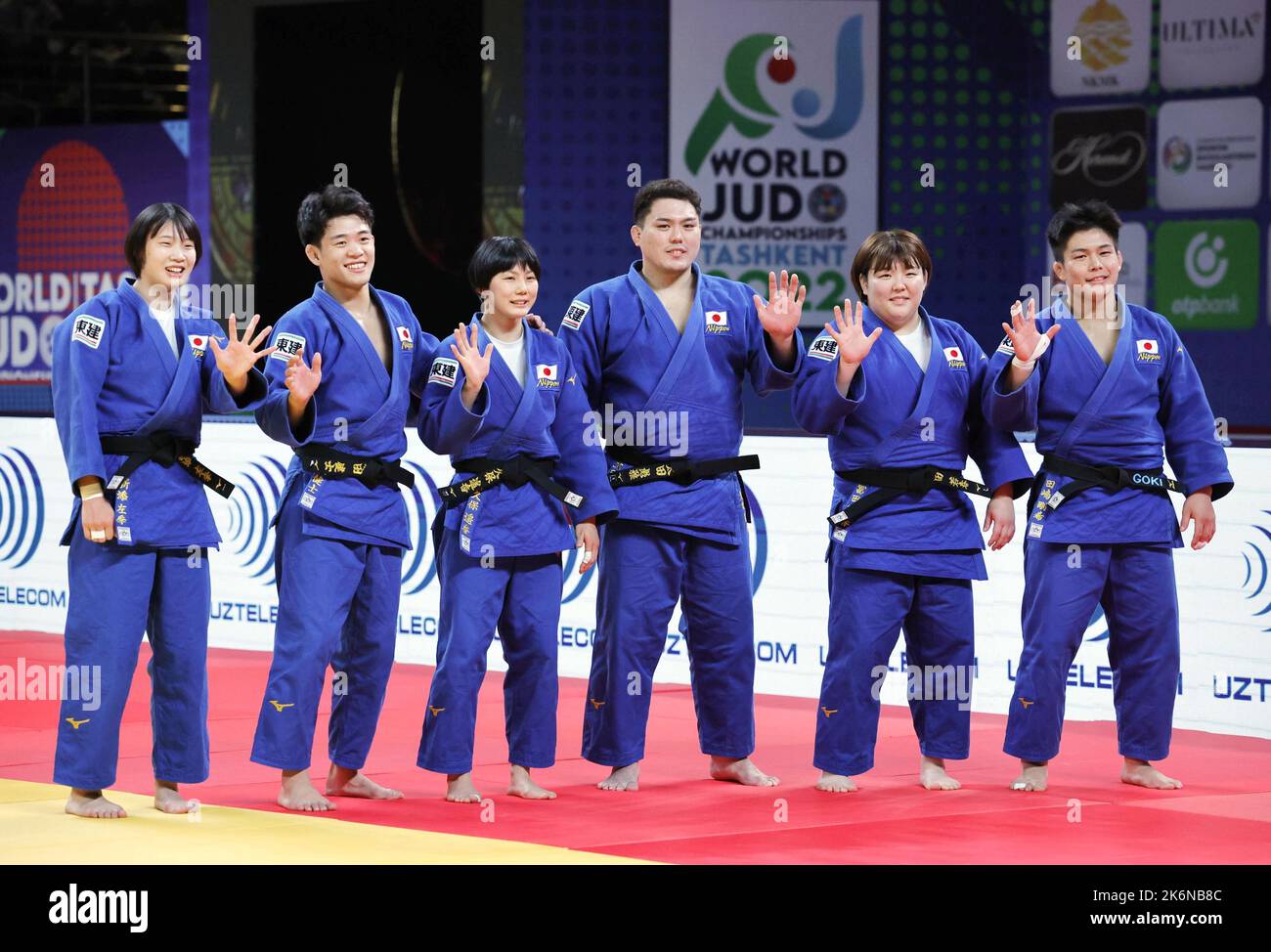 Members of Japan's gold-winning mixed team celebrate at the judo world ...