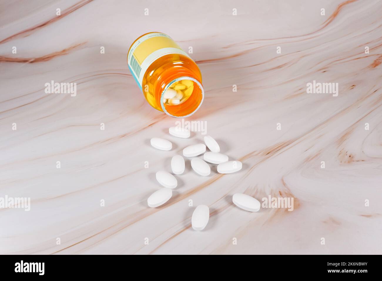 Statin tablets spilled out open container on marble counter Stock Photo ...